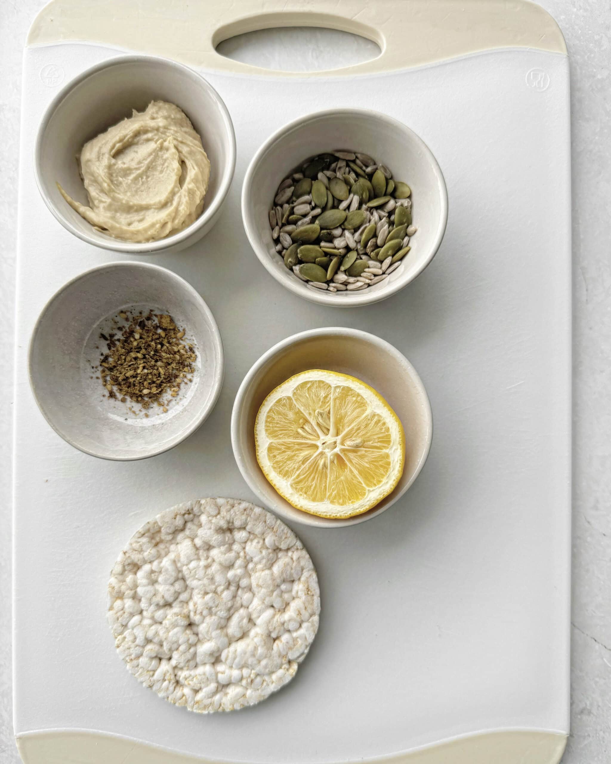 Hummus Rice Cakes with Seeds & Dukkah - Nourish & Tempt