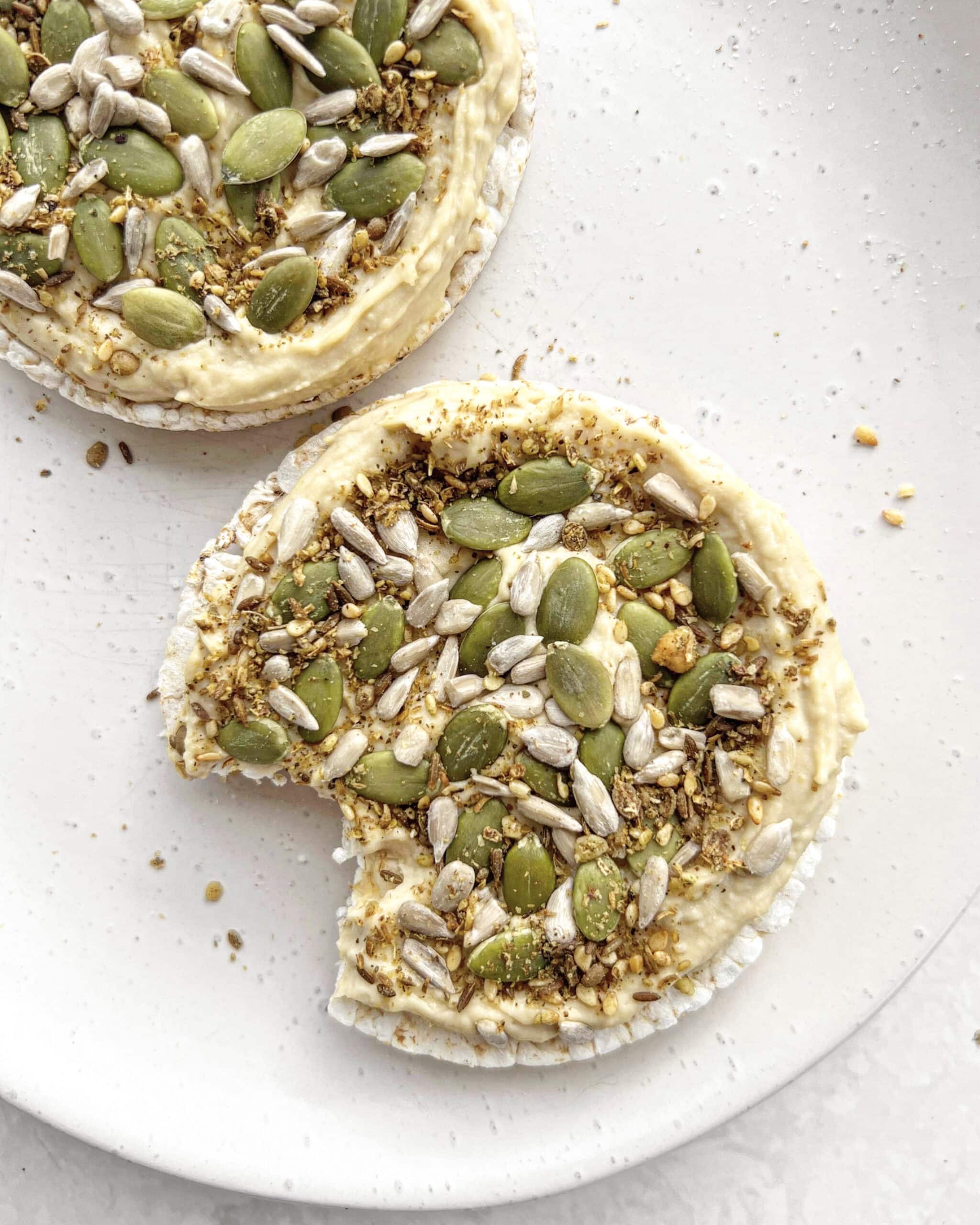 Hummus Rice Cakes with Seeds & Dukkah - Nourish & Tempt